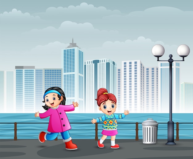 Cheerful Kids Playing on Waterfront Promenade with Cityscape | Jiffy ...